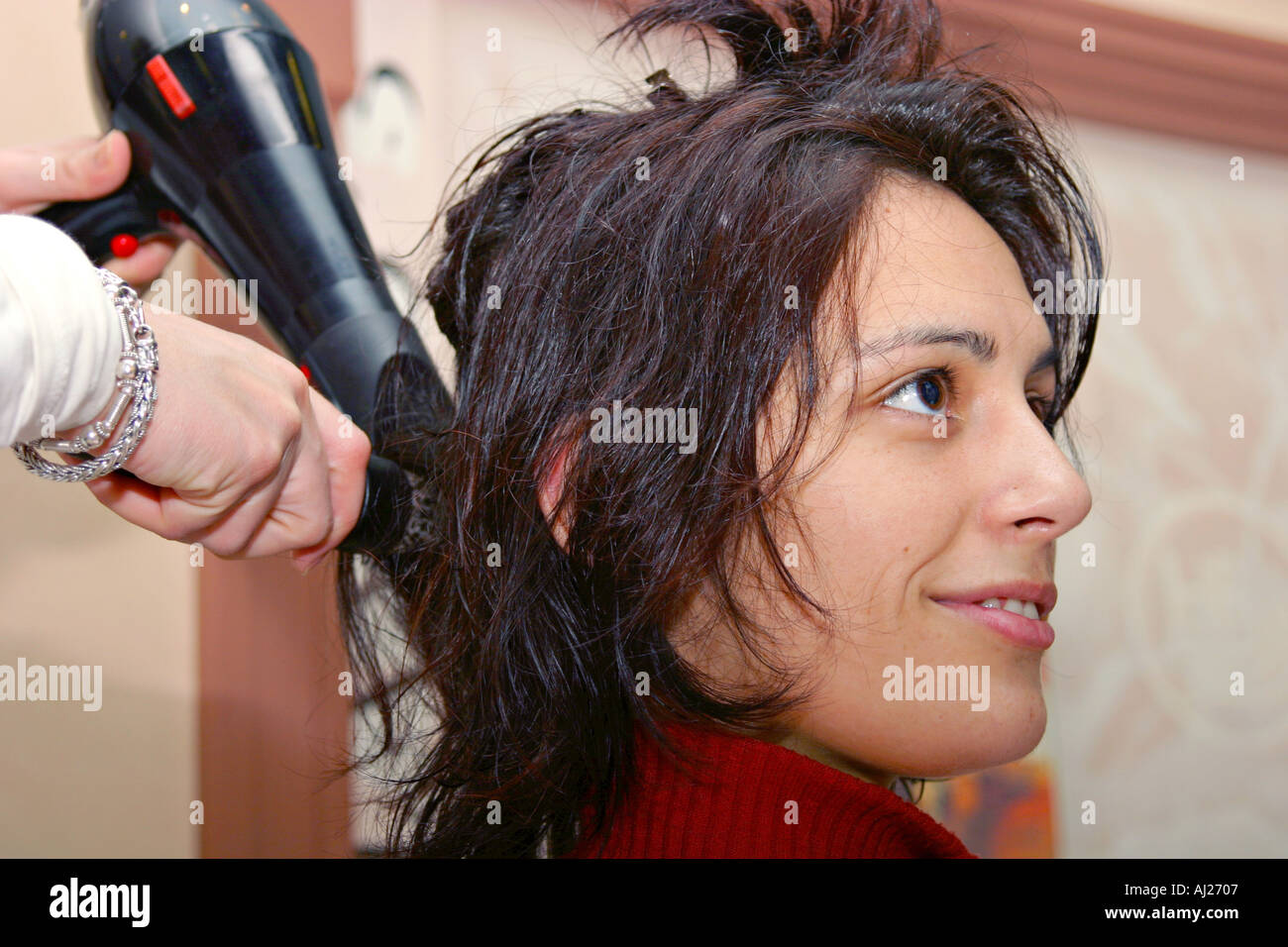 Young woman getting her hair done salon hi-res stock photography and ...