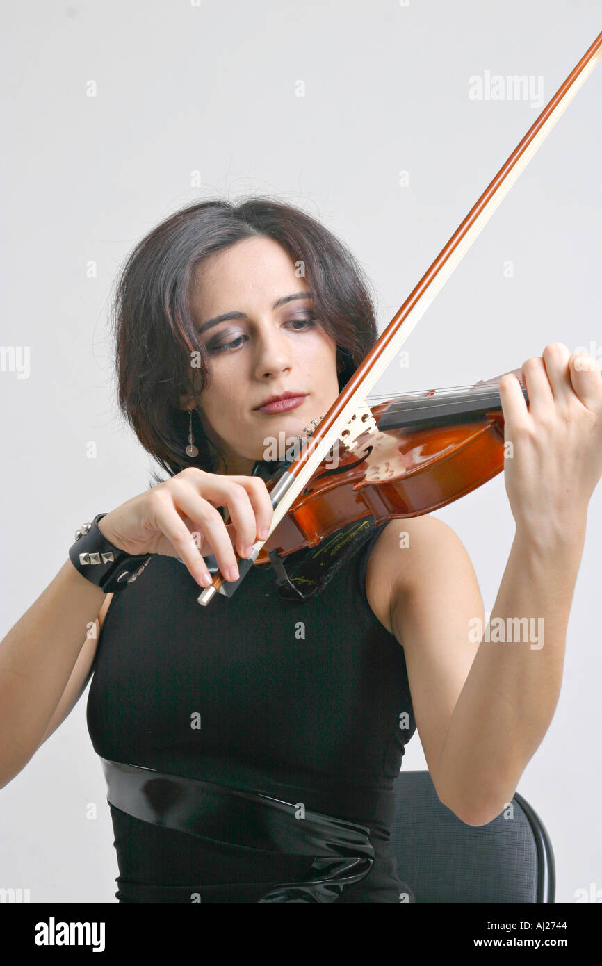 Young woman with heavy rock or punk appearance playing the violin Stock ...