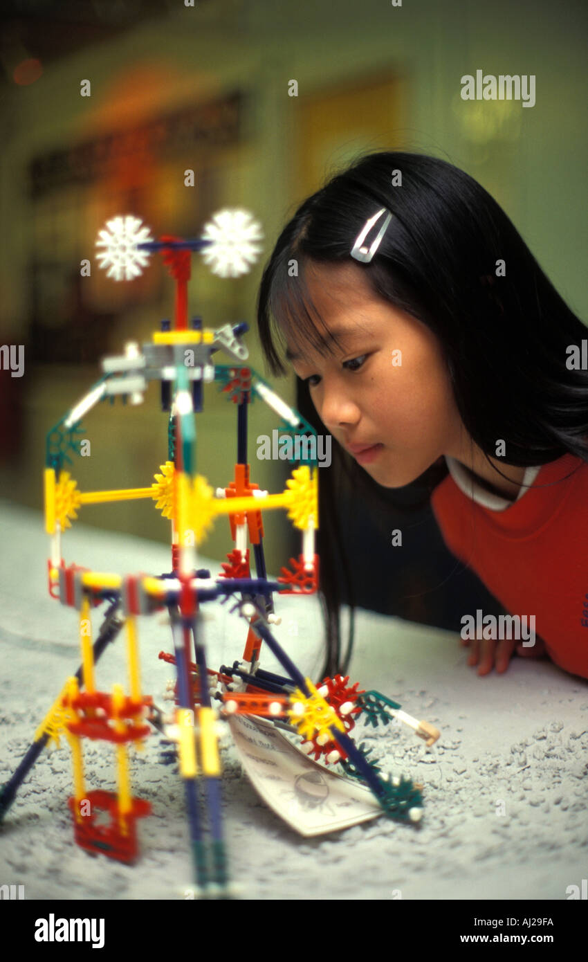 School girl examining work done in a science class, Southwark, London ...