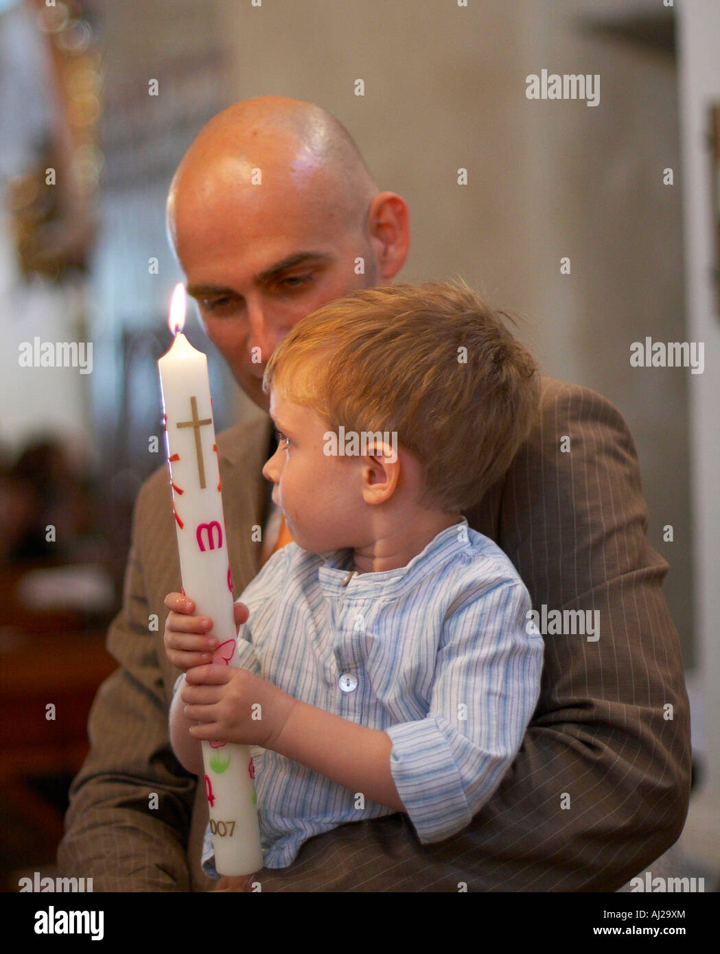 father and child with baptism candle Stock Photo - Alamy