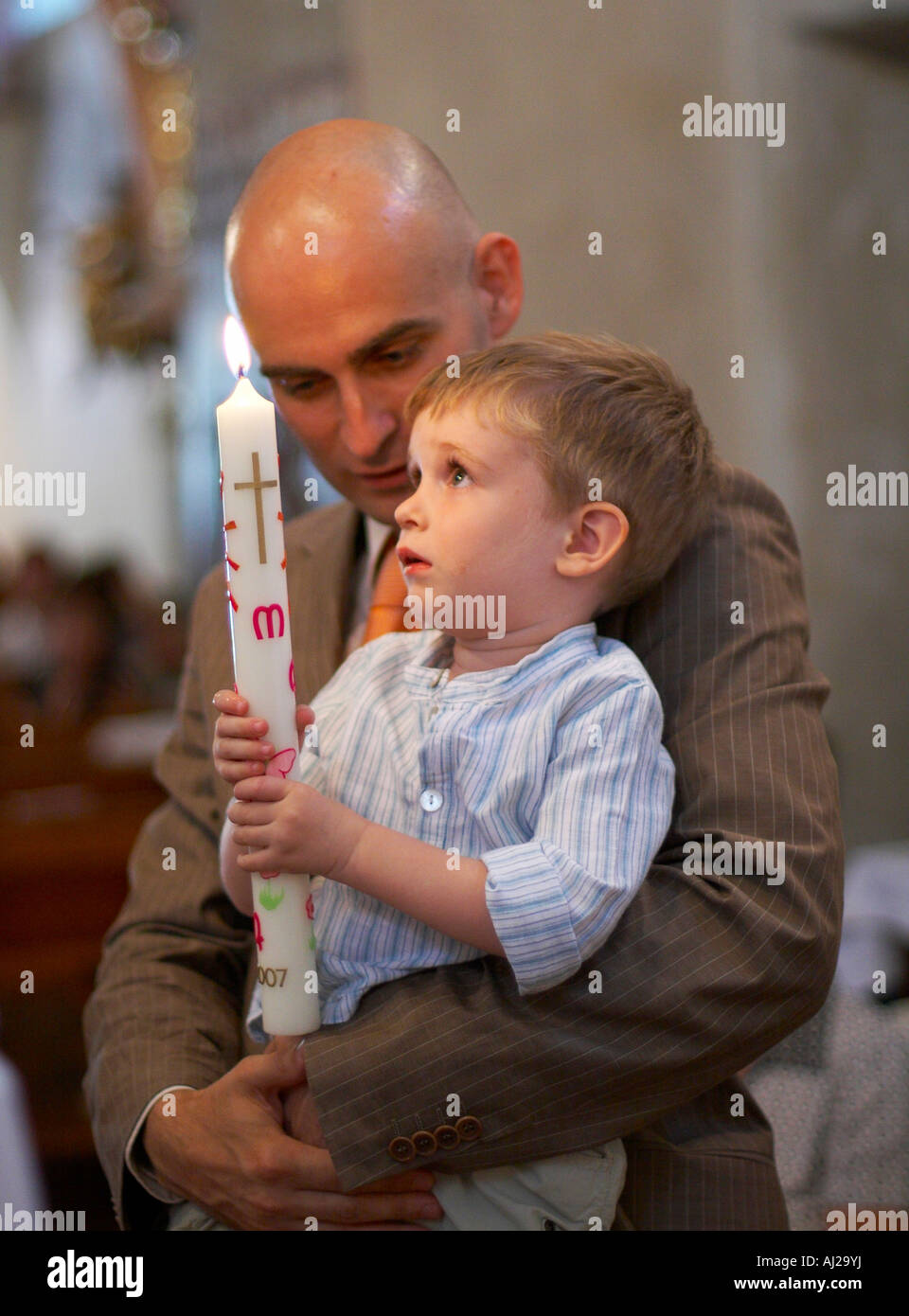father and child with baptism candle Stock Photo - Alamy