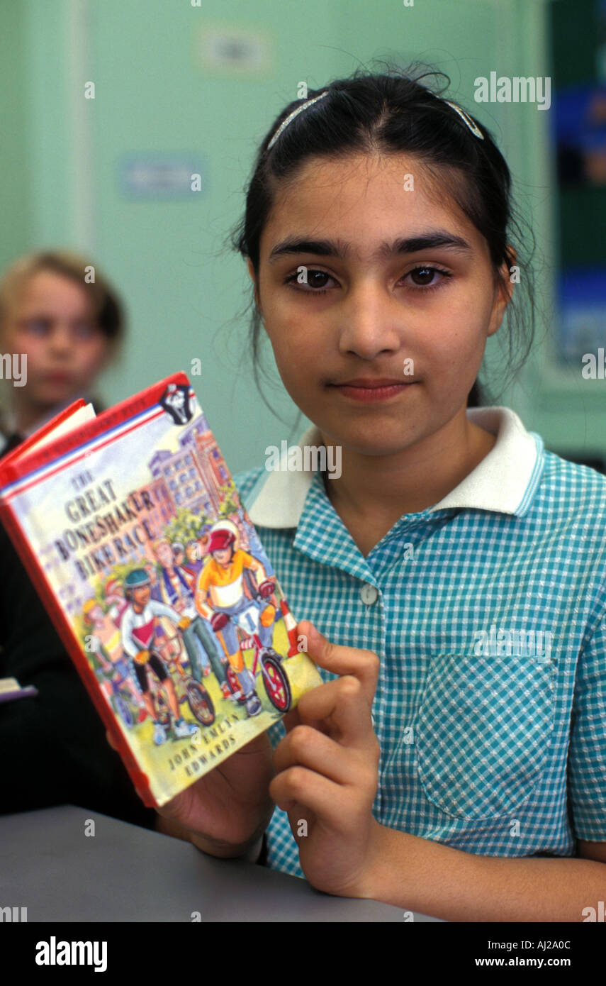 Primary school pupil in class with book, Hillingdon, London England ...