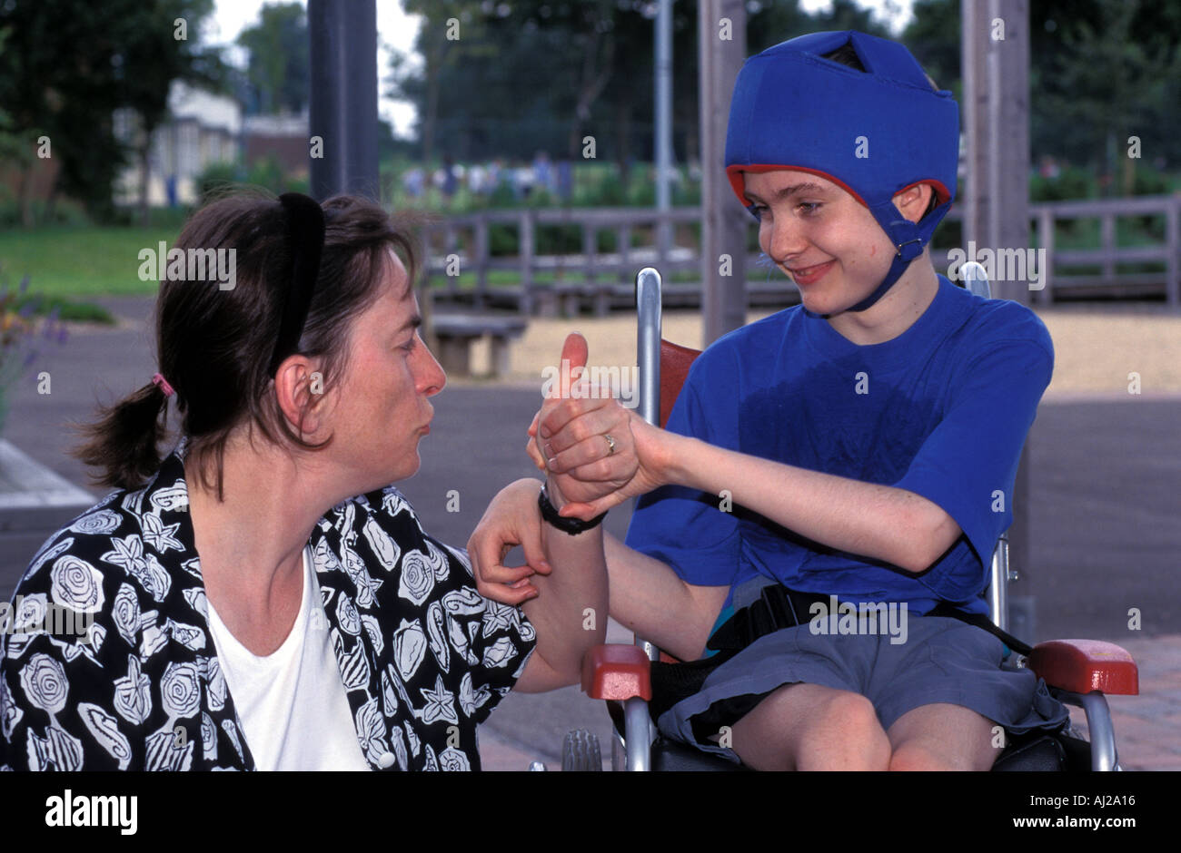 Young autistic boy with school staff member, London, UK Stock Photo - Alamy