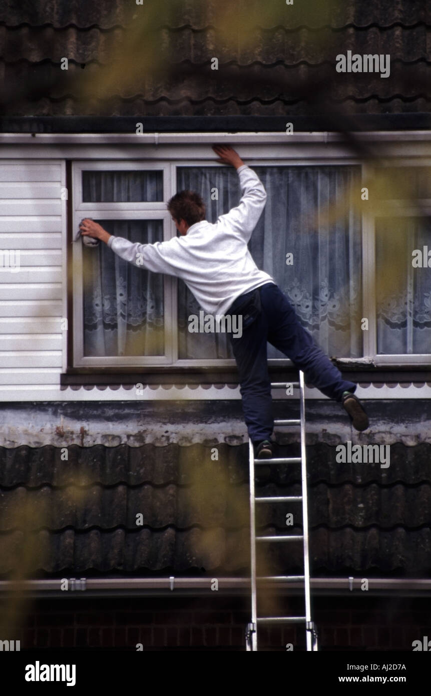 How to end up falling off a ladder back view of man in precarious ...