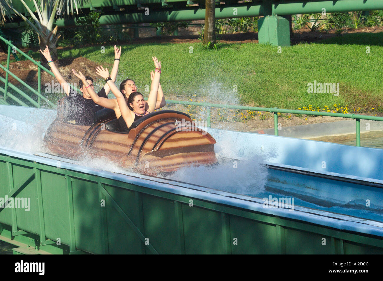 Amusement park visitors splashing down in water ride Stock Photo - Alamy