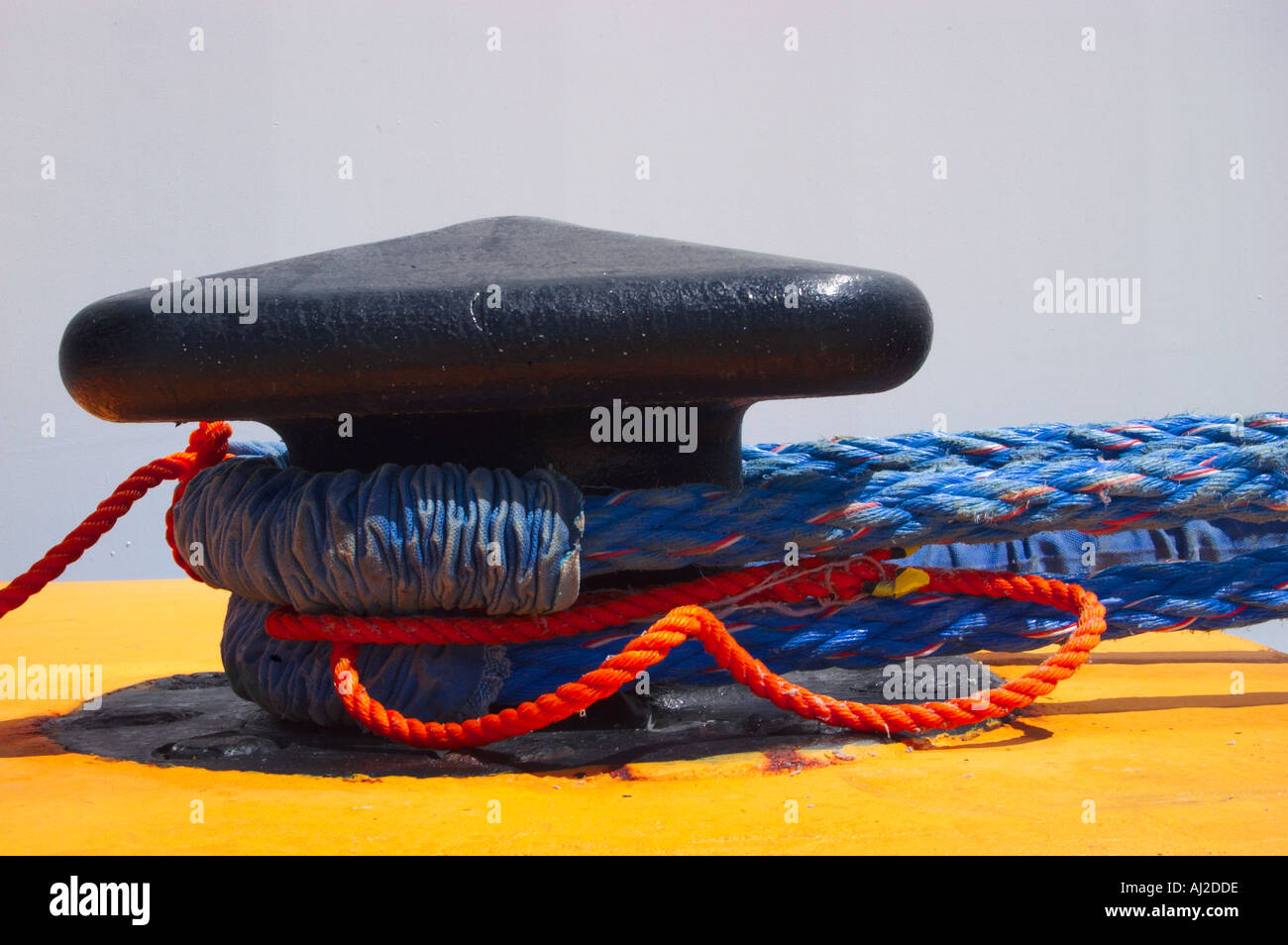 Bollard holding ship ropes Stock Photo - Alamy