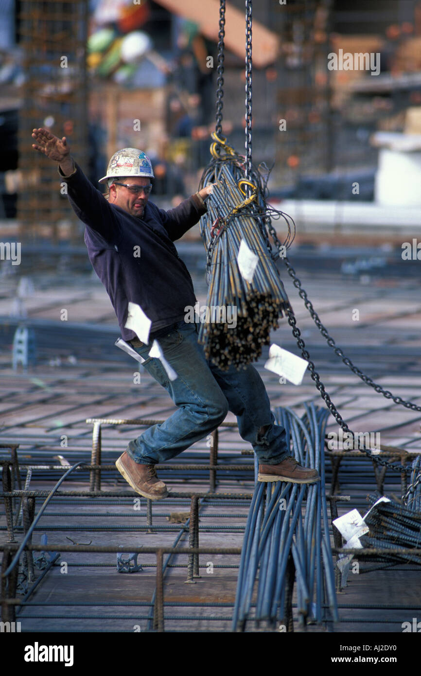 USA Washington Seattle Iron worker directs load of re bar at office ...