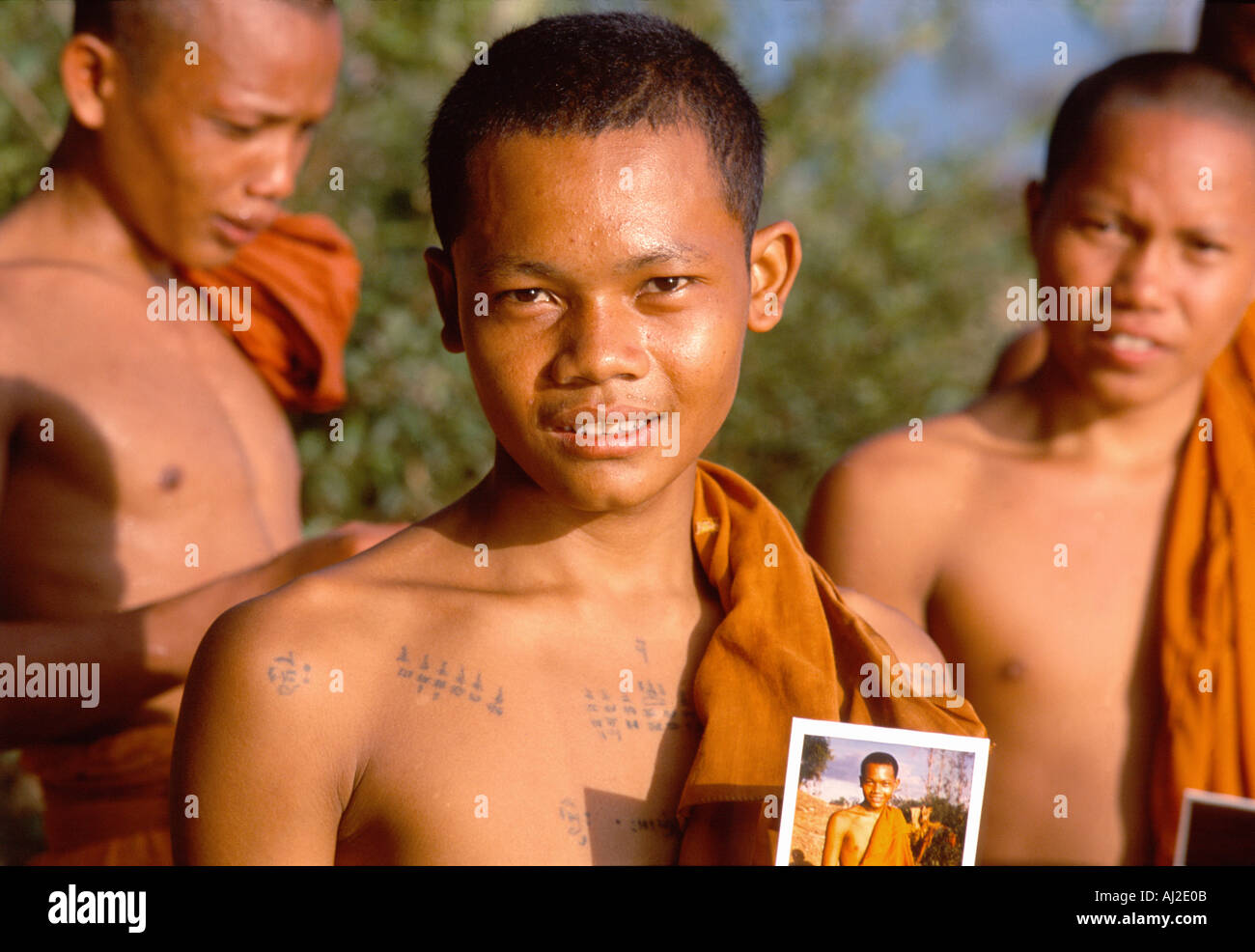 Young monks with souvenir portrait polaroids after an afternoon swim ...