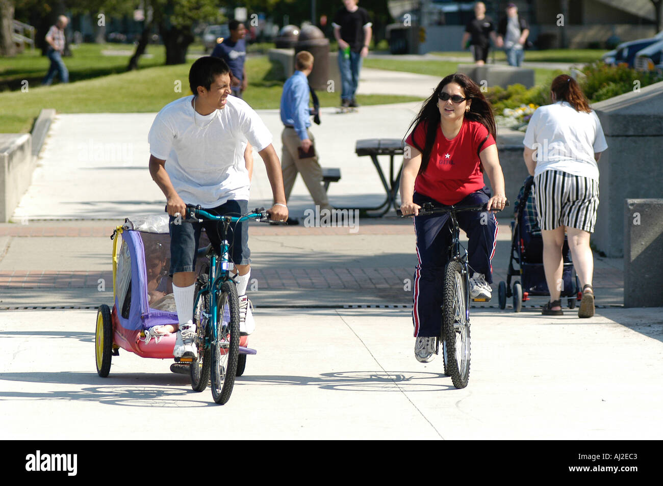 Mixed Race Couple Ride Bicycles on Boardwalk Stock Photo - Alamy