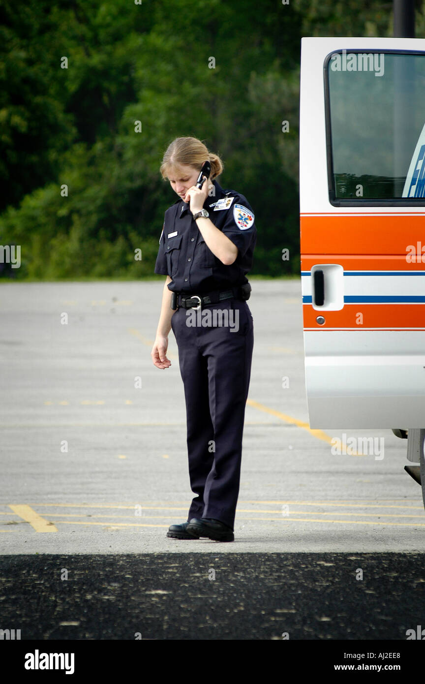 Female Ambulance Person Communicates by Cell Phone Stock Photo - Alamy