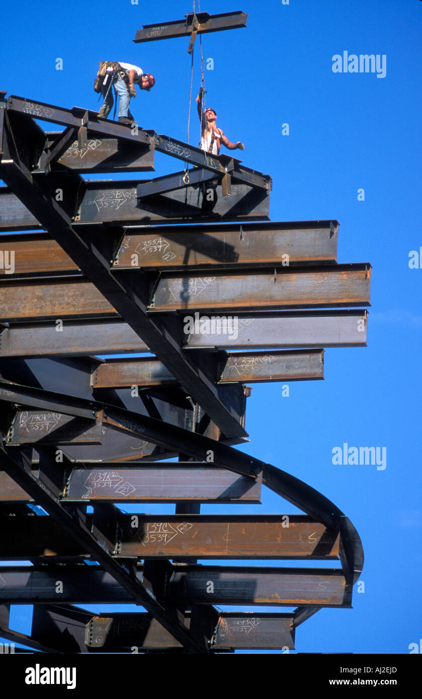 USA Washington Seattle Construction workers bolt steel beams onto frame ...