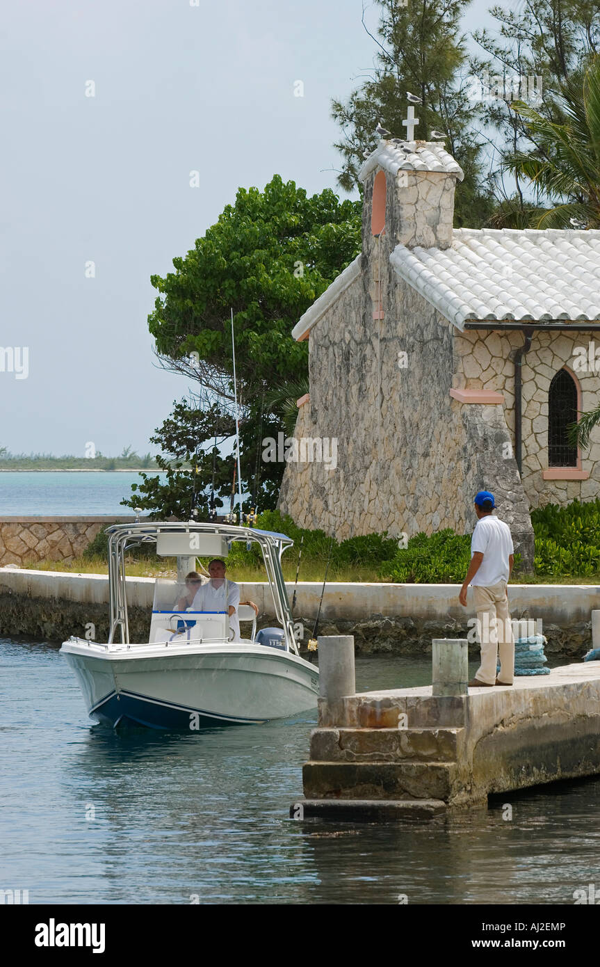 Overlooked by the island's rustic chapel, a boat enters the harbour at ...