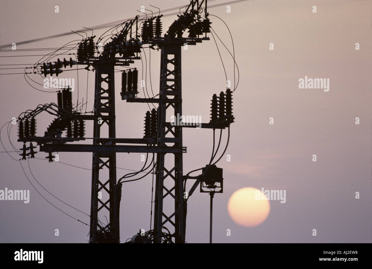 Israel Tel Aviv Setting sun behind electrical transmission tower and ...