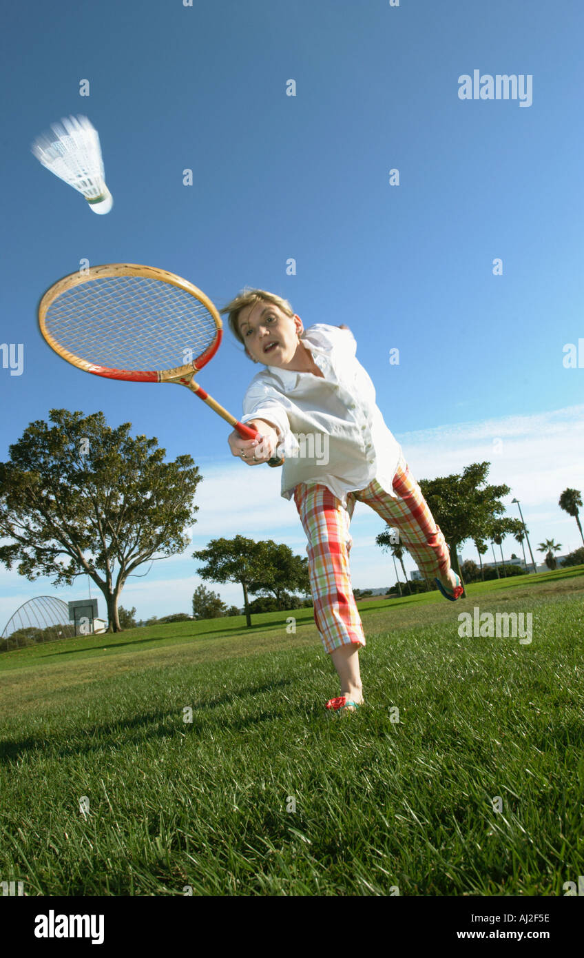 A woman plays badminton in a park Stock Photo - Alamy