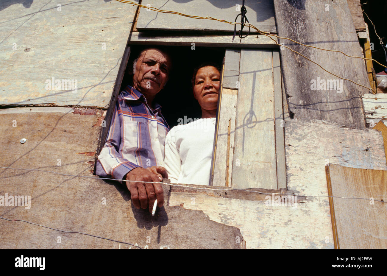A family in the window of their home in a favela in Sao Paulo Stock ...