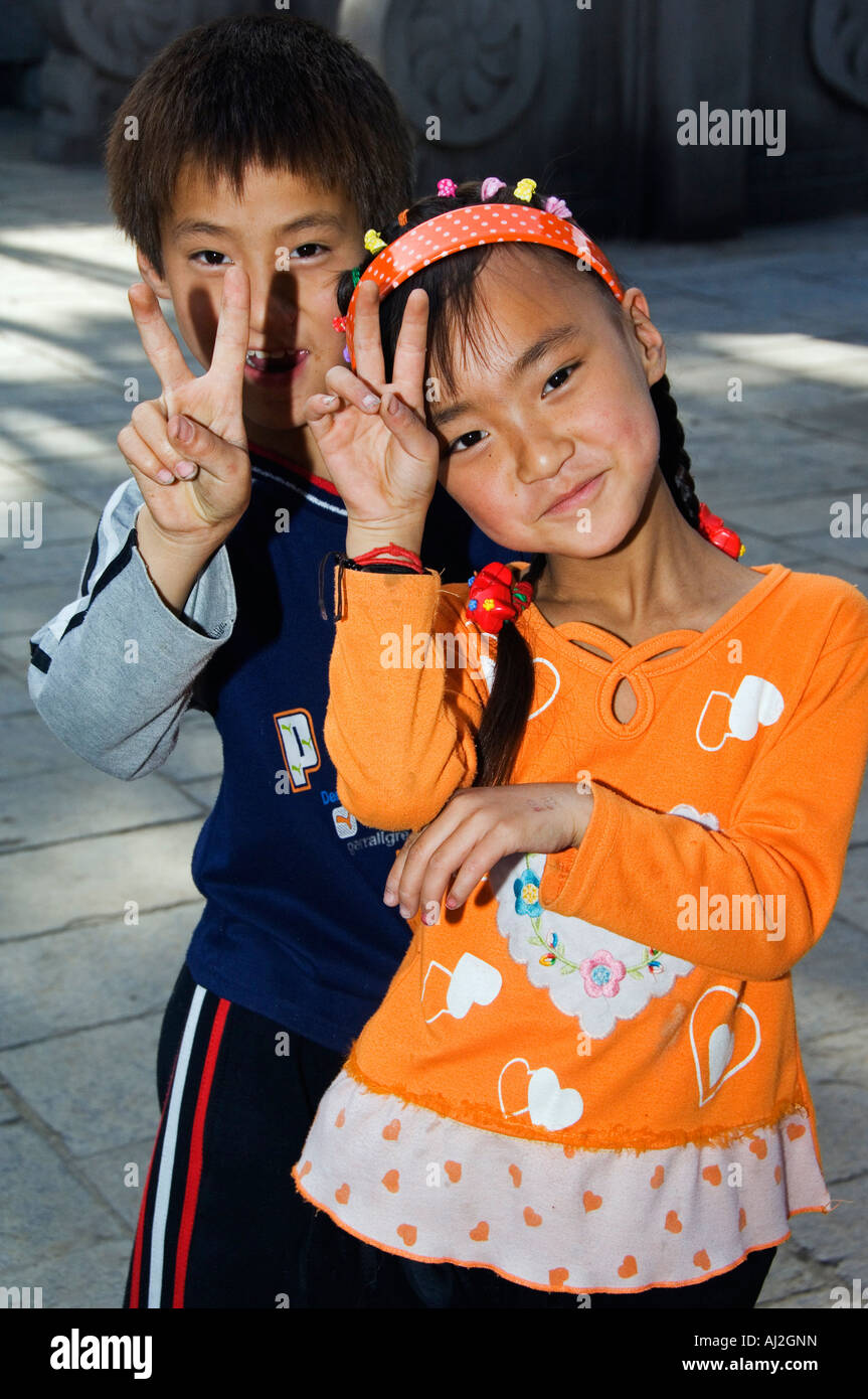 A young Chinese girl and boy posing for the camera, Xian City, Shaanxi ...