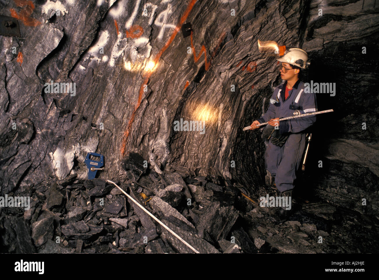 Canada Ontario MR Geologist Albert Chong takes ore samples in mine ...