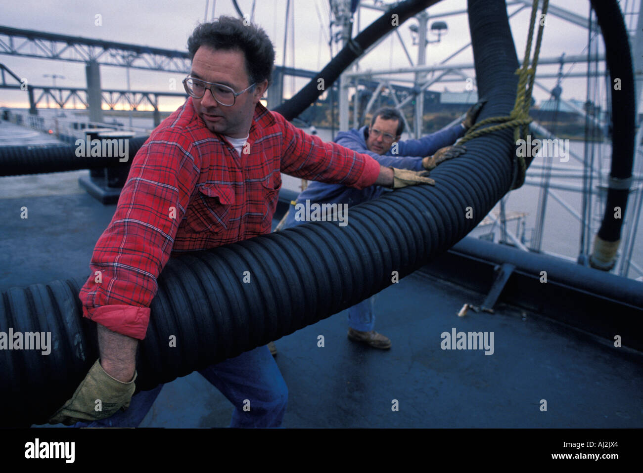 USA California Crew on Oil tanker Arco Juneau wrestles with hose while ...