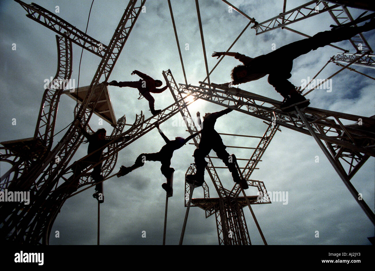 Young acrobats, some balanced on stilts doing an elaborate street ...