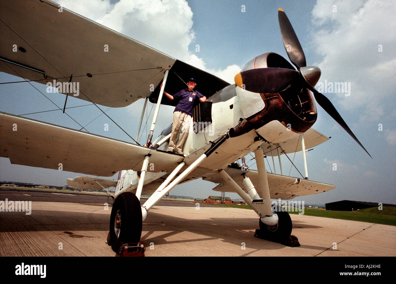 Former pilot John Tupper stands on the wing of his Swordfish biplane ...