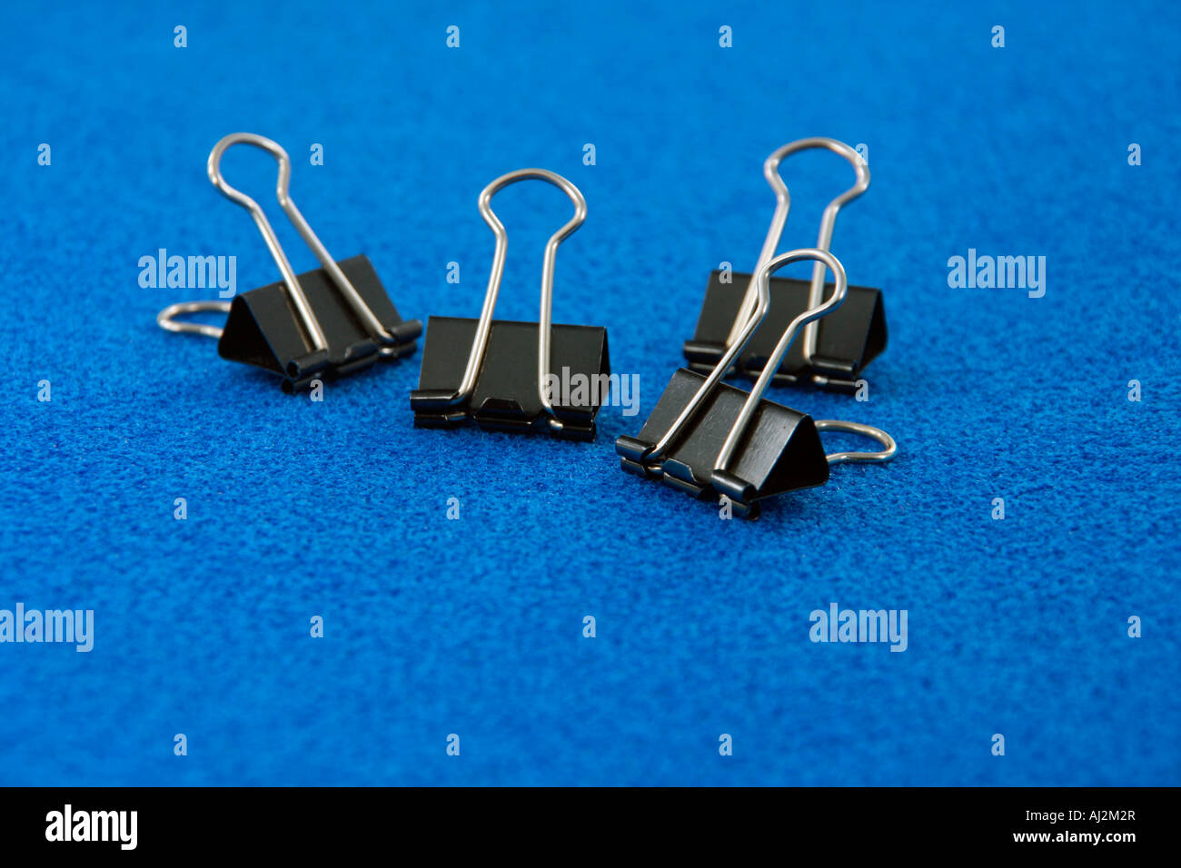 paper binders in blue background office stationary Stock Photo - Alamy