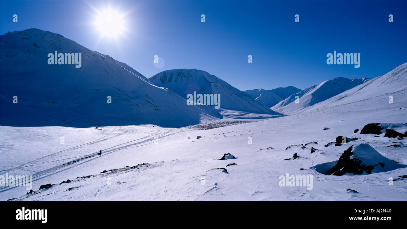 USA Alaska Musher races over Rainy Pass in Alaska Range peaks on clear ...