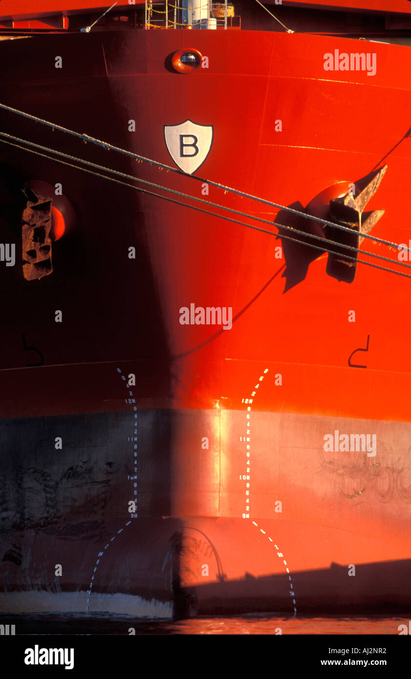 USA Washington Seattle Setting sun lights bow of cargo ship loading at ...