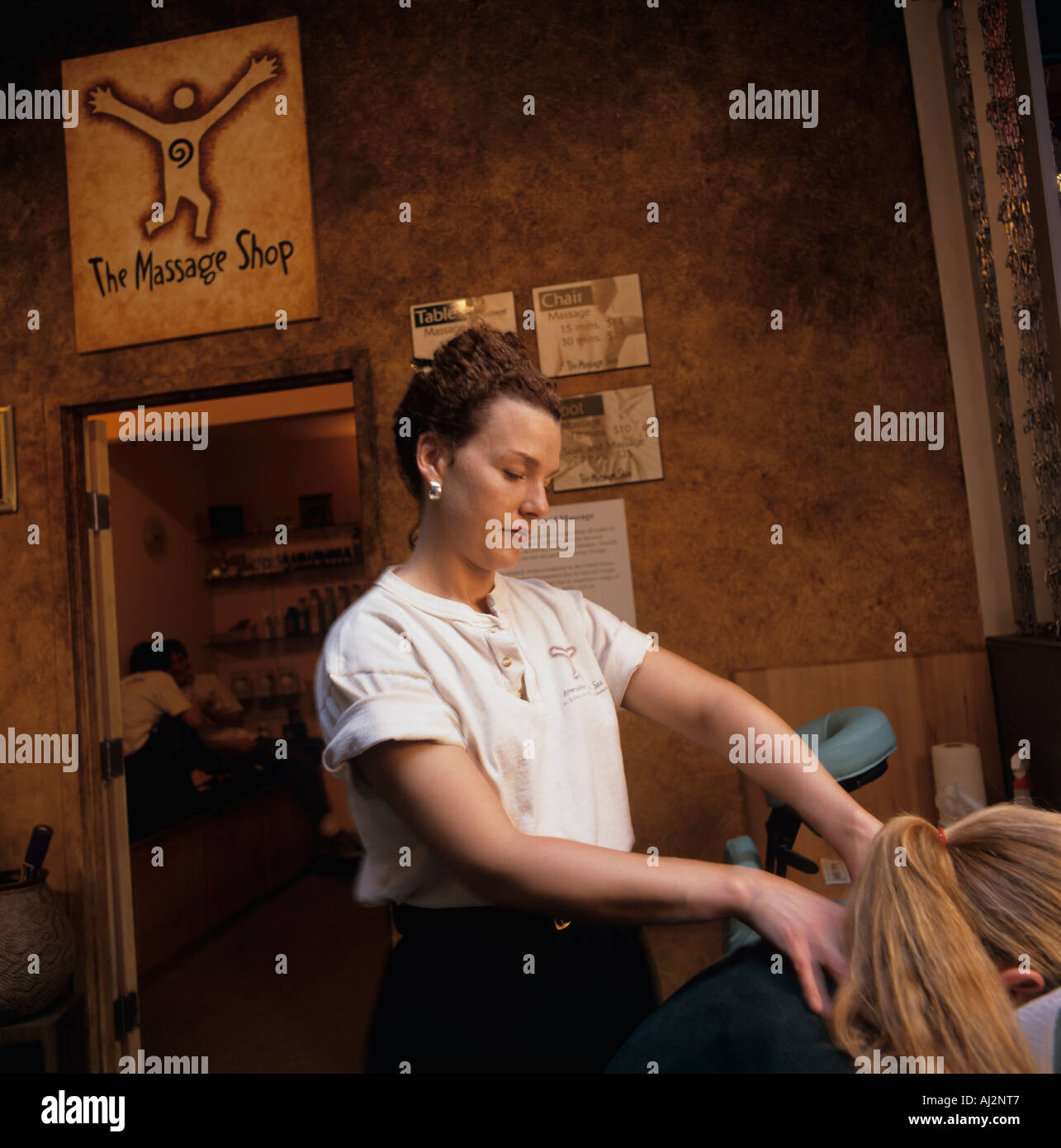 USA Washington Seattle Greer Clark rubs customer s back and neck at The ...