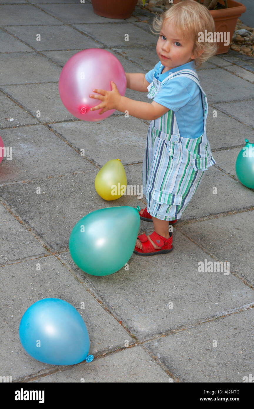 little child playing with balloons Stock Photo - Alamy