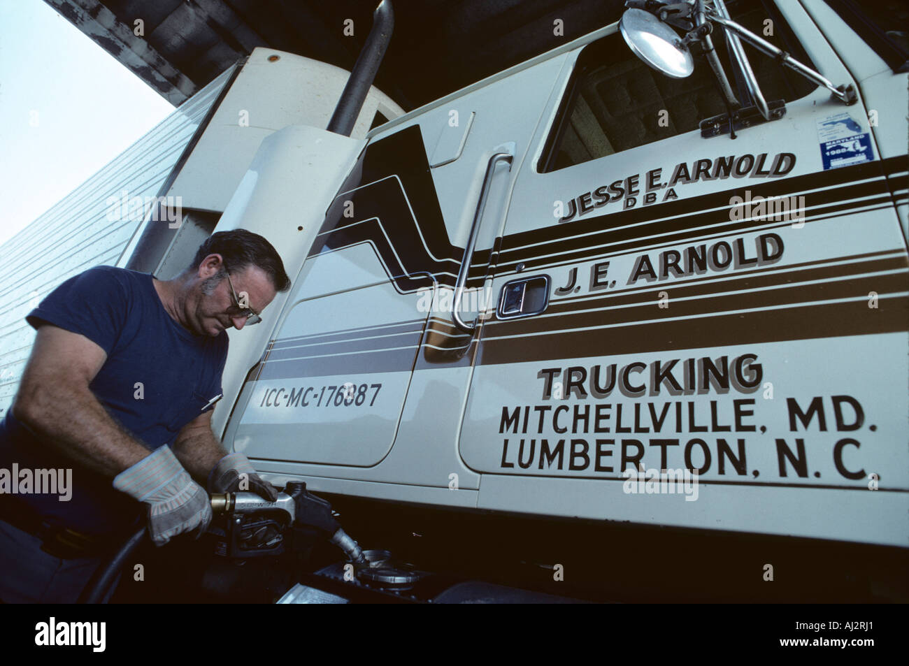 USA, North Carolina, (MR) Trucker Jesse Arnold fills diesel tanks of ...