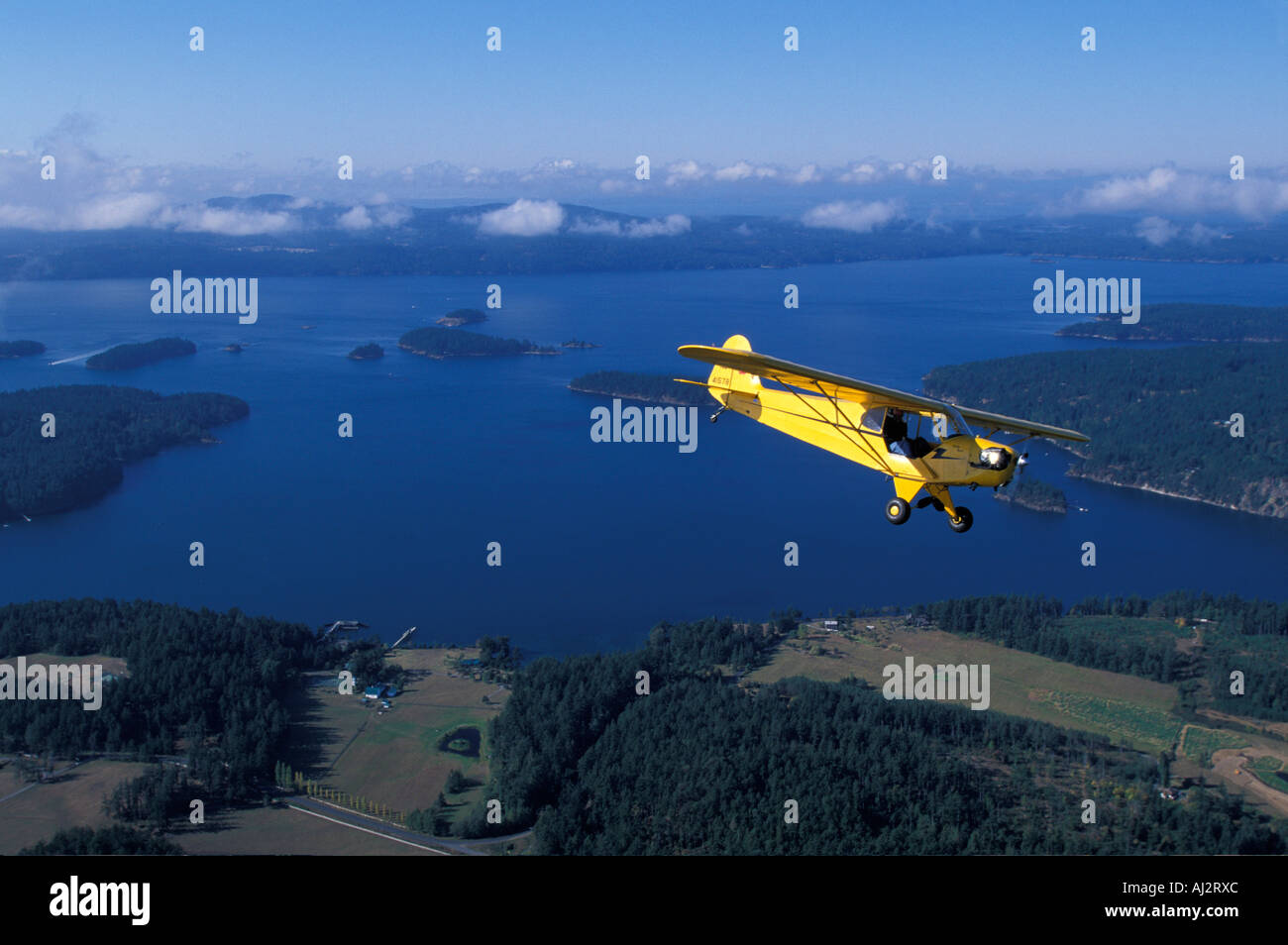 USA Washington Author Richard Bach pilots Piper Cub airplane over Orcas ...