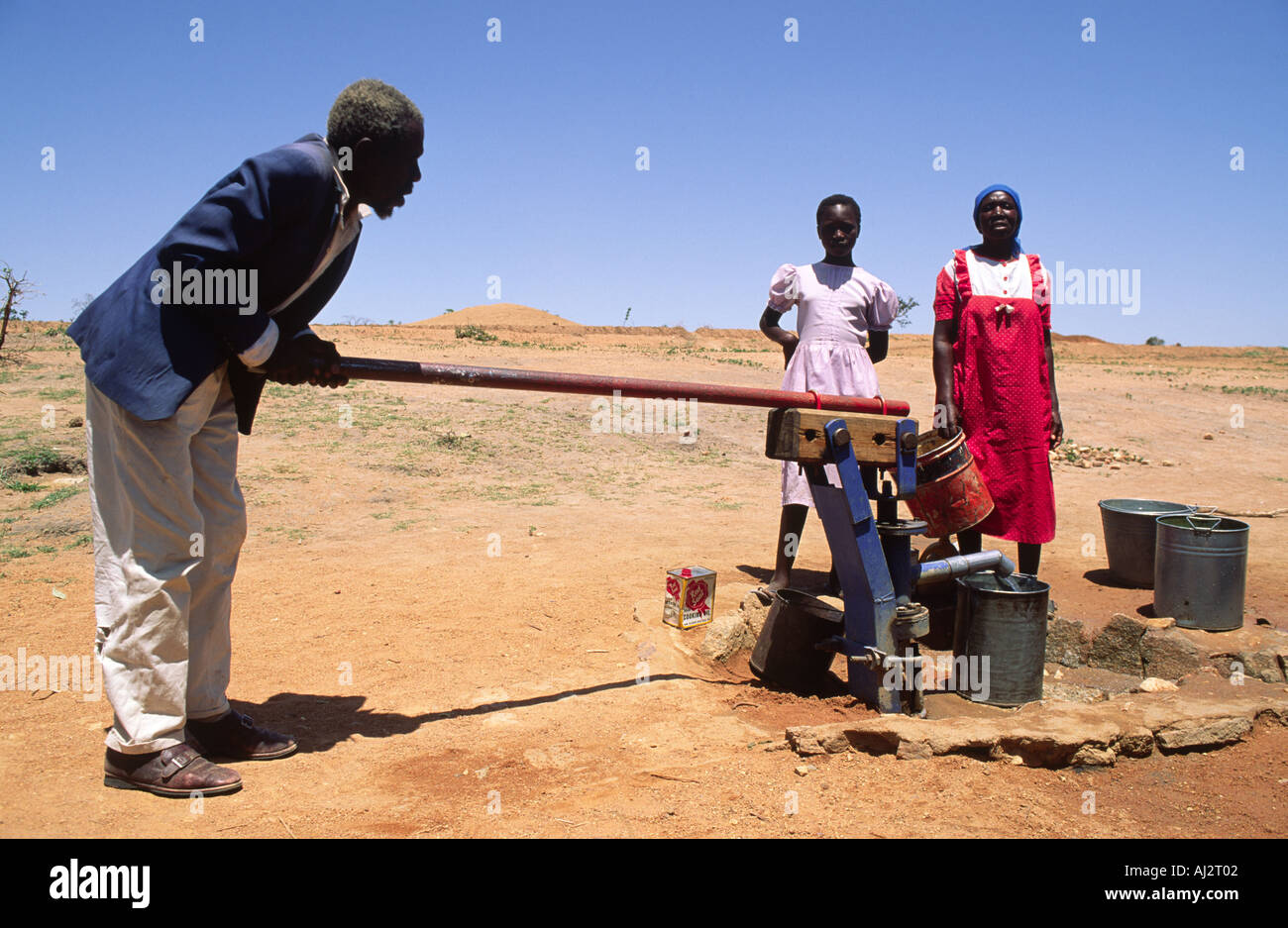 Man pumping water. This is the traditional women's role and this man ...
