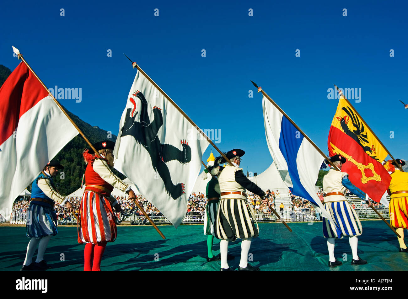 Regional flags of Switzerland are paraded at the Unspunnen Bicentenary ...