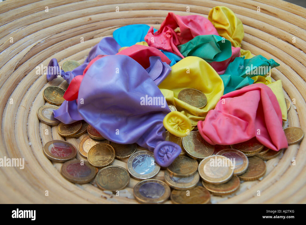 burstes balloons with coins Stock Photo - Alamy