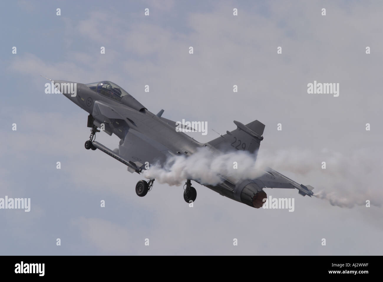 Saab J-39C Gripen fighter interceptor laking off with wingtip smoke ...