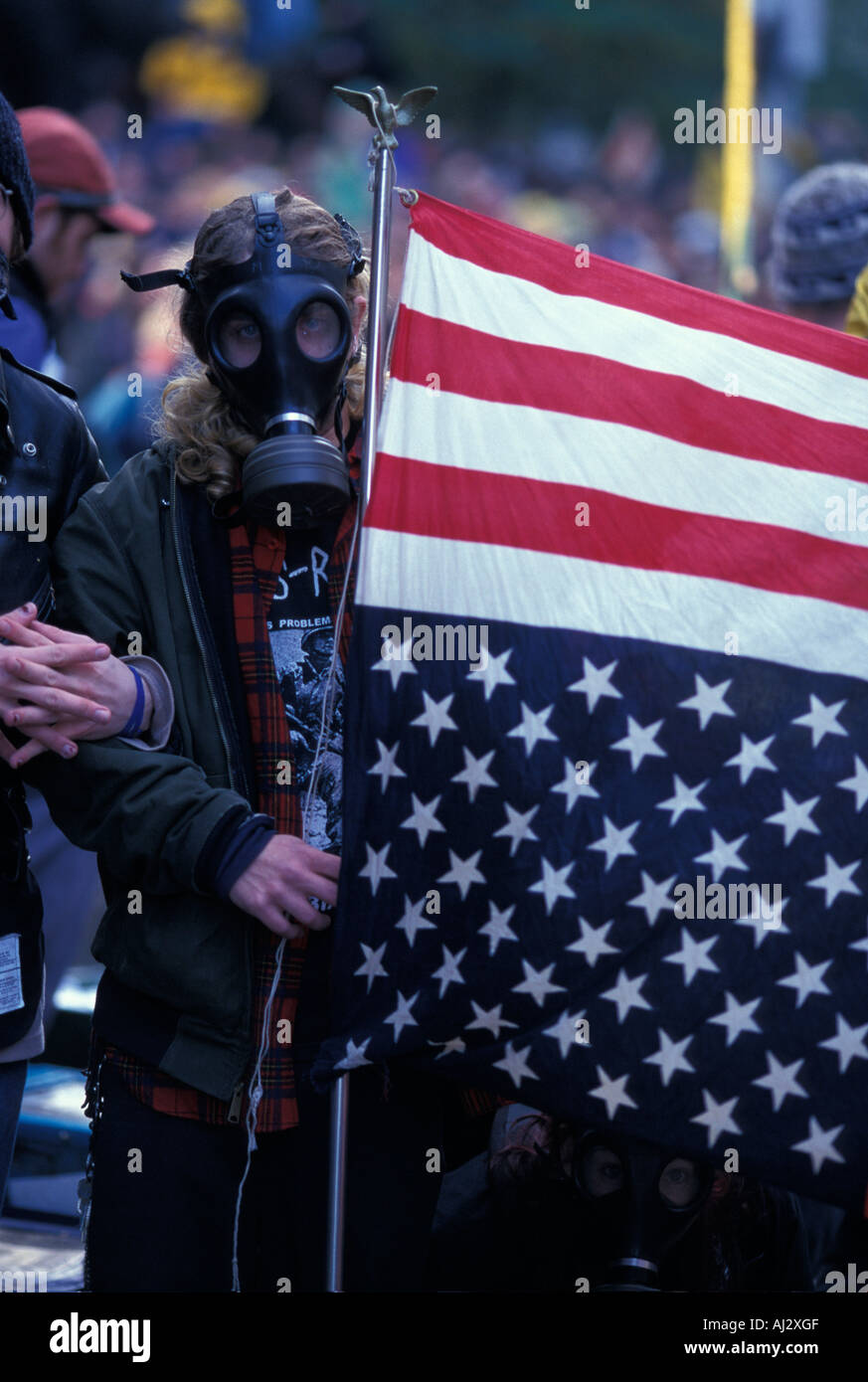 USA Washington Seattle Masked protester holds American flag during anti ...