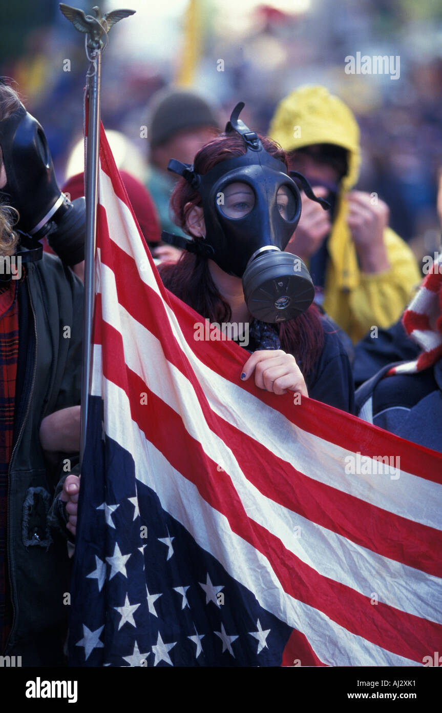 USA, Washington, Seattle, Masked protesters hold American flag during ...