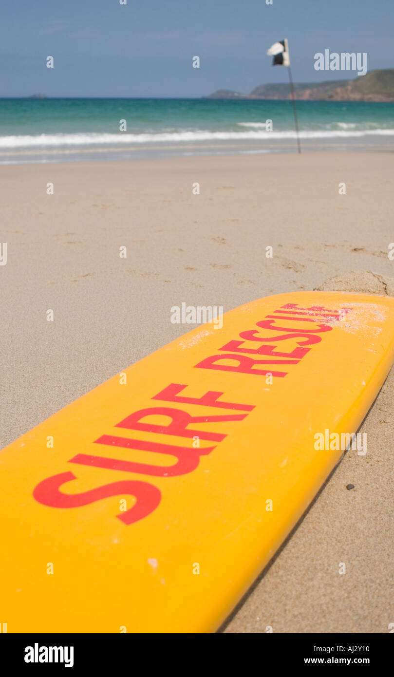 A yellow surf rescue surfboard on the beach at Sennen Cornwall UK with ...