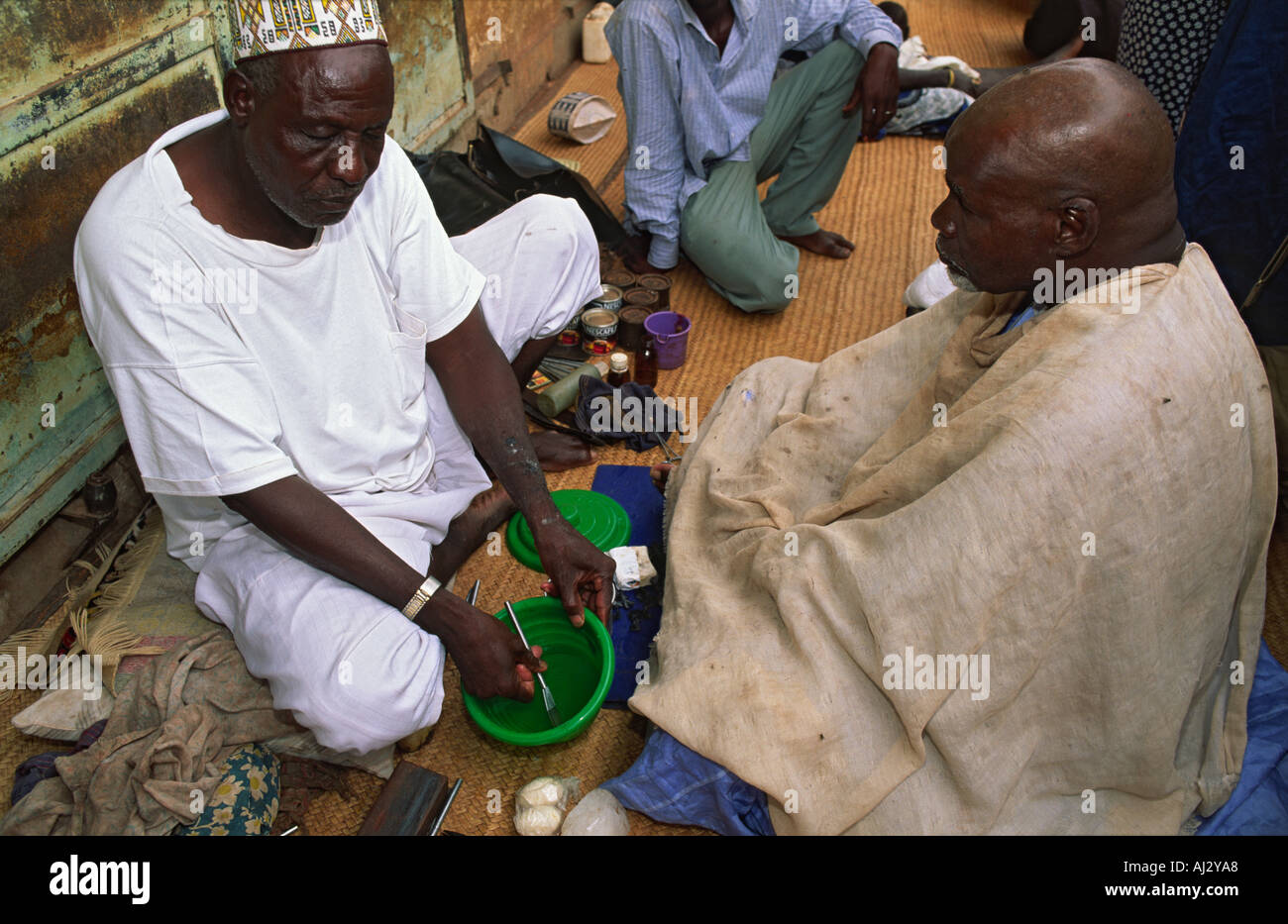 A streetside barber disinfects his razor, a direct result of an HIV ...