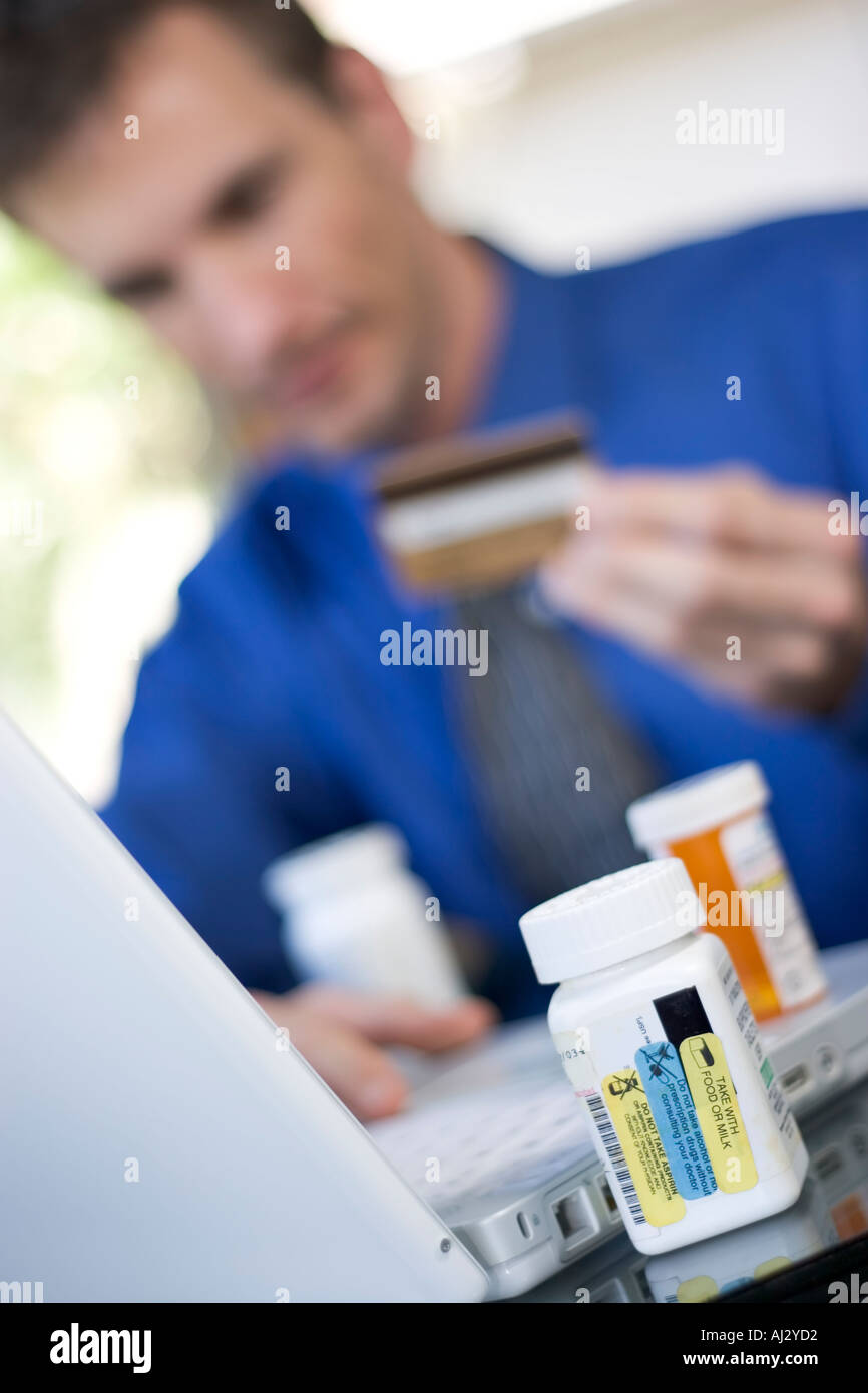 Man purchasing pharmaceuticals online using his credit card Stock Photo ...
