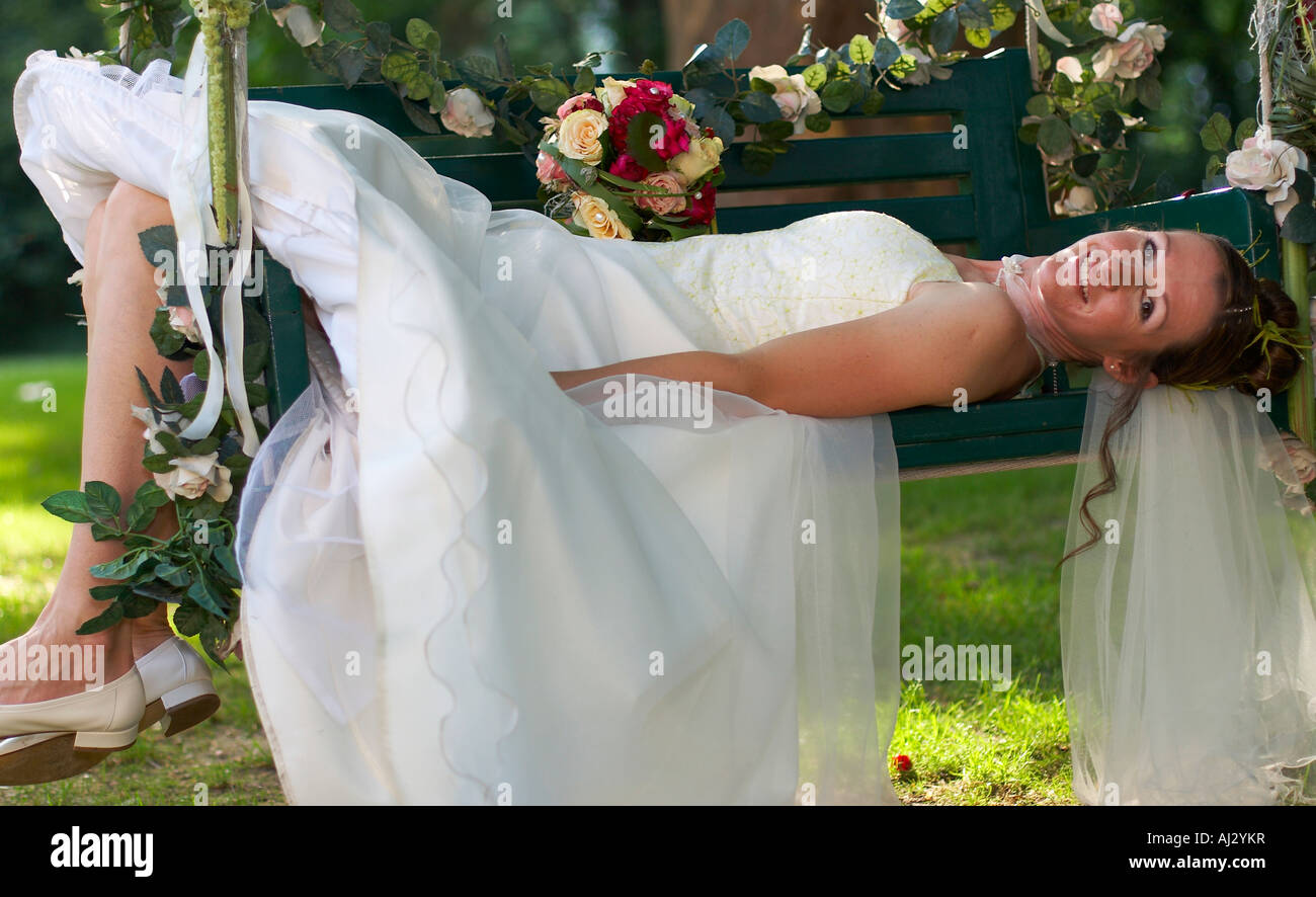 bride lying on swing Stock Photo - Alamy
