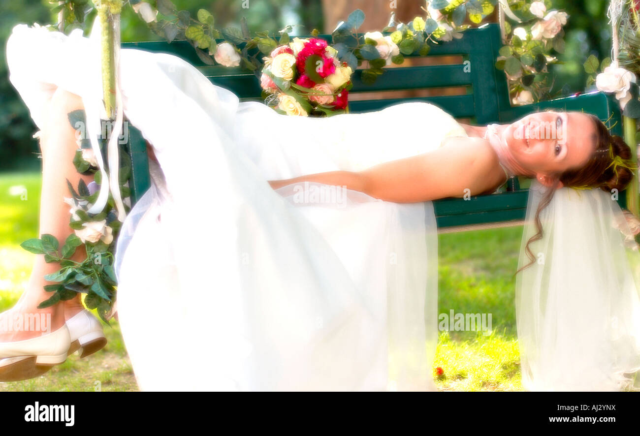 bride lying on swing Stock Photo - Alamy