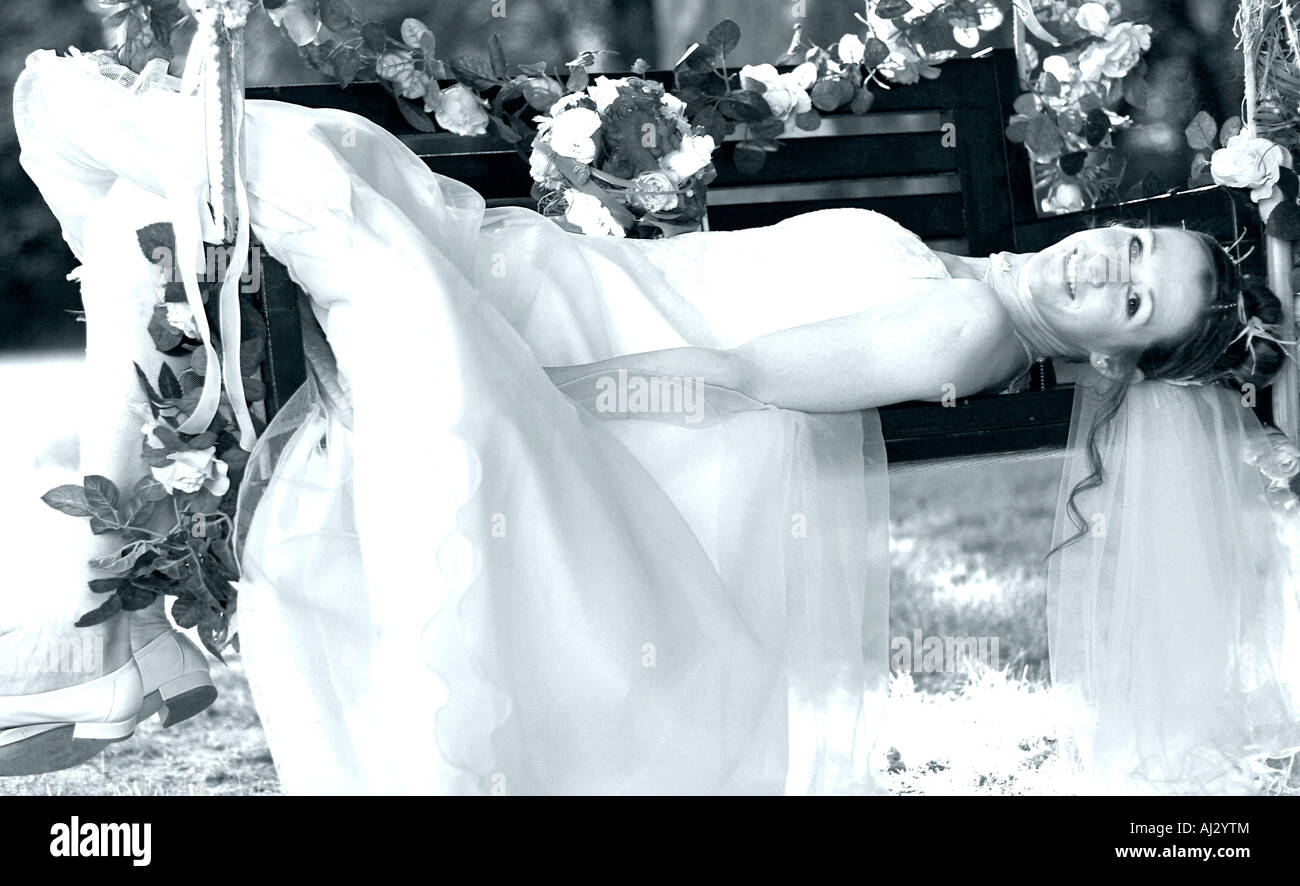 bride lying on swing Stock Photo - Alamy