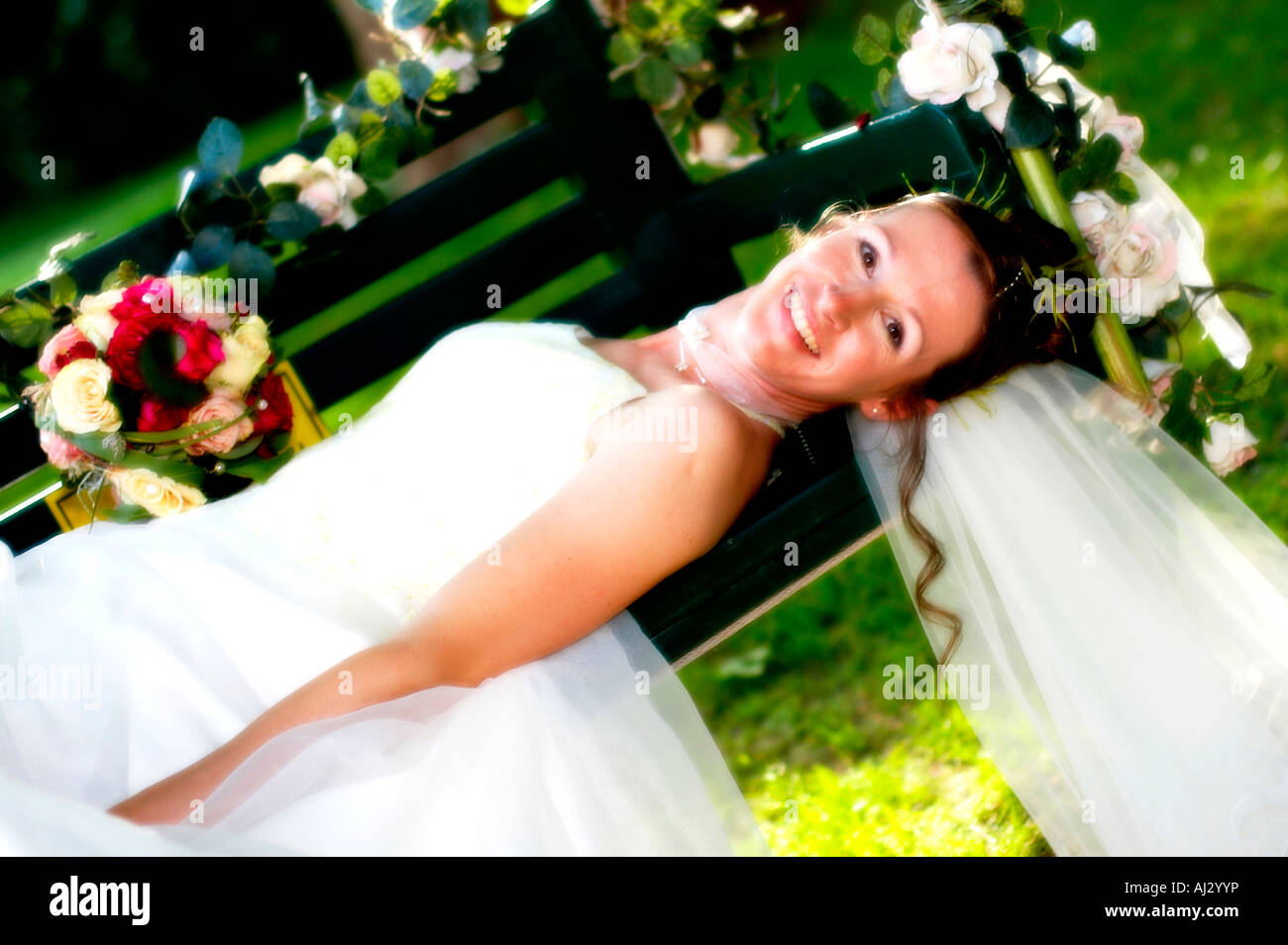 bride lying on swing Stock Photo - Alamy