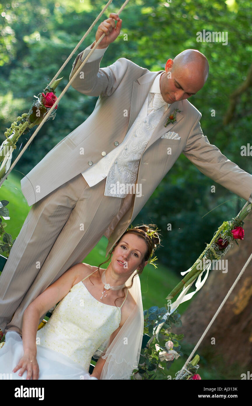 bridal couple on swing Stock Photo - Alamy