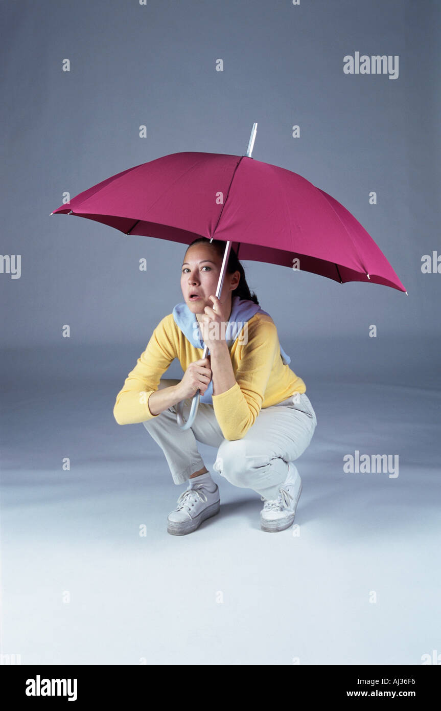 Woman crouching scared hi-res stock photography and images - Alamy