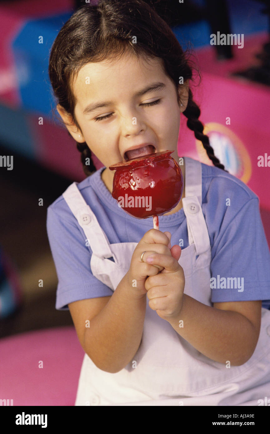 Girl eating caramel apple hi-res stock photography and images - Alamy