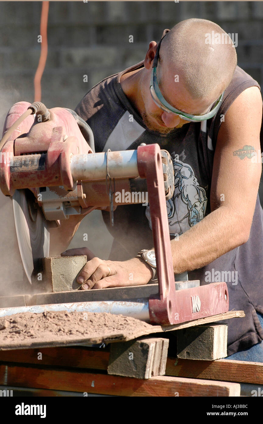 Male Mason Cuts Bricks Stock Photo - Alamy