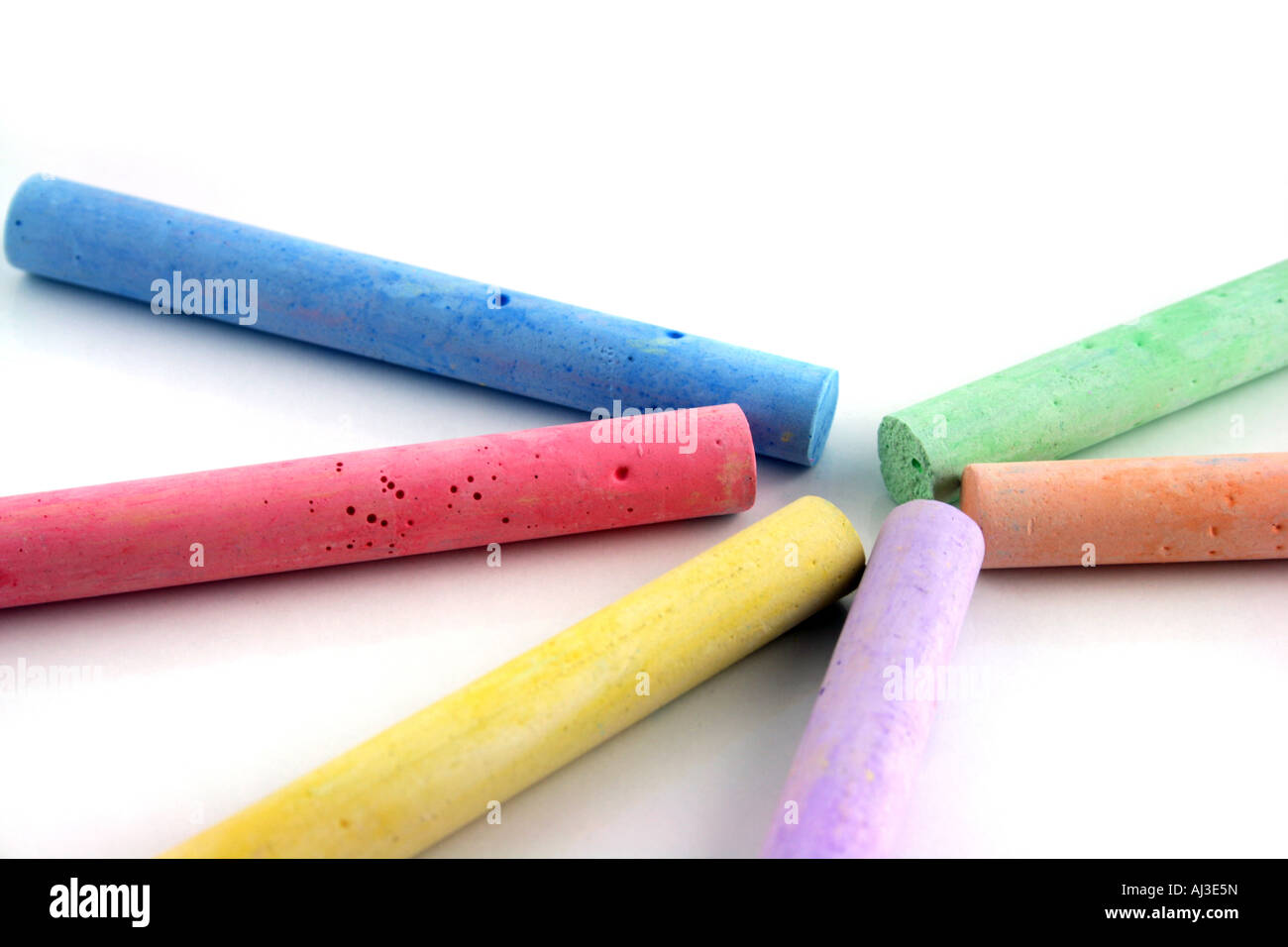 Brightly colored chalks on a white reflective background Stock Photo ...
