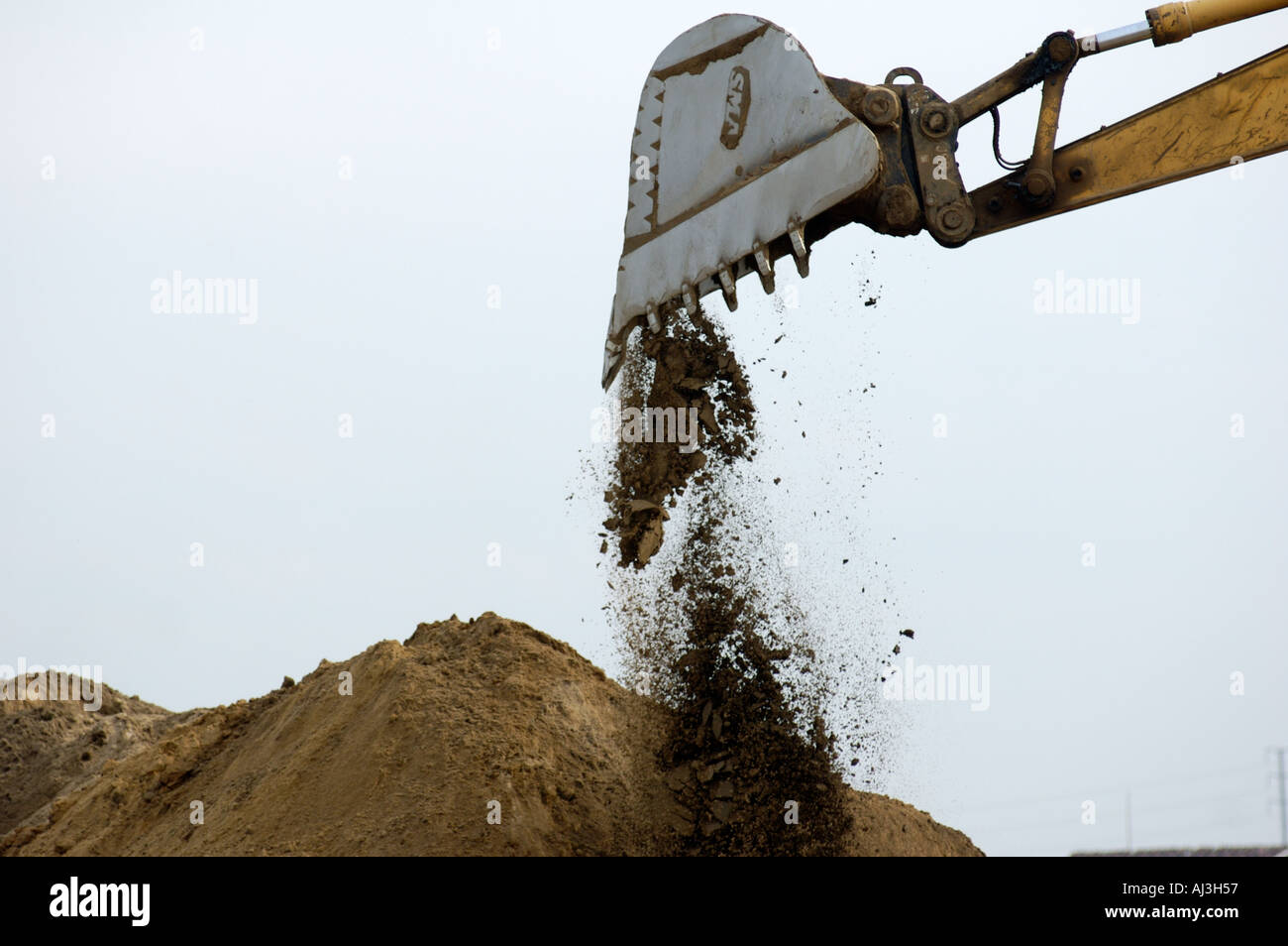 Backhoe Dumping Dirt Stock Photo - Alamy